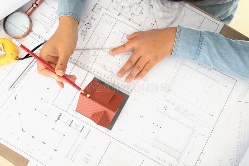 The Architect is Revising the Construction Drawings Against the House ...