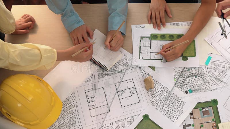 Architects Discuss about House Construction Design with Blueprint ...
