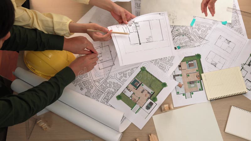 Architects Discuss about House Construction Design with Blueprint ...