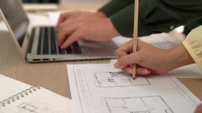 Close Up of Architect Hand Writing Detail of Blueprint with Laptop ...