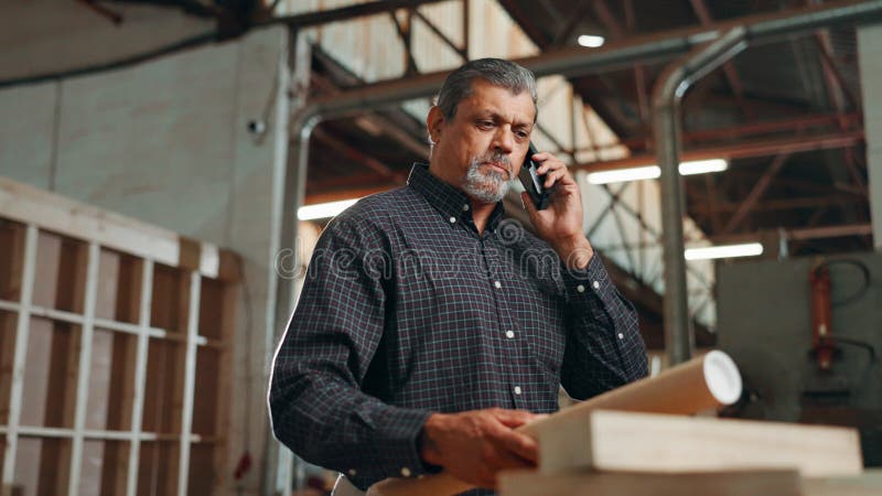 Architect, Serious Discussion and Man with Phone Call in Warehouse for ...