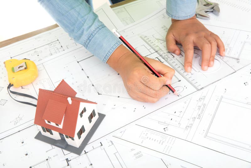 The Architect is Seriously Revising the Drawings on the Table Stock ...