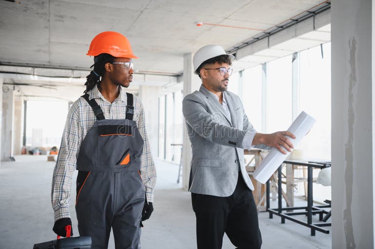 Architect Showing Blueprints To Builder during Construction Site Visit ...