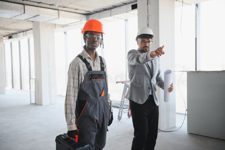 Architect Showing Instructions To Builder during Building Construction ...