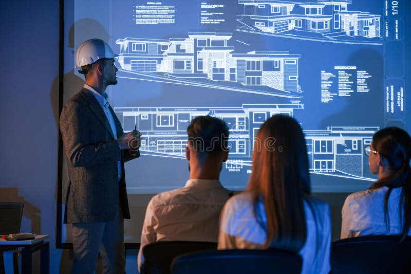 Architect Showing Plan of Building. Male Leader Talking To Employees ...