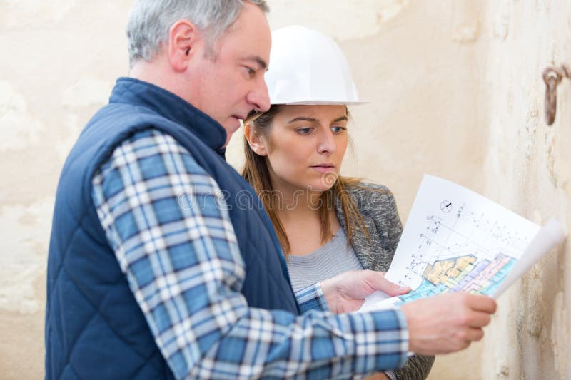 Architect on Site Discussing Plans with Builder Stock Photo - Image of ...