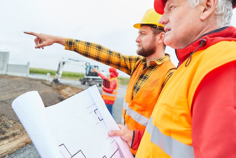 Architect and Site Manager with Floor Plan on the Construction Site ...