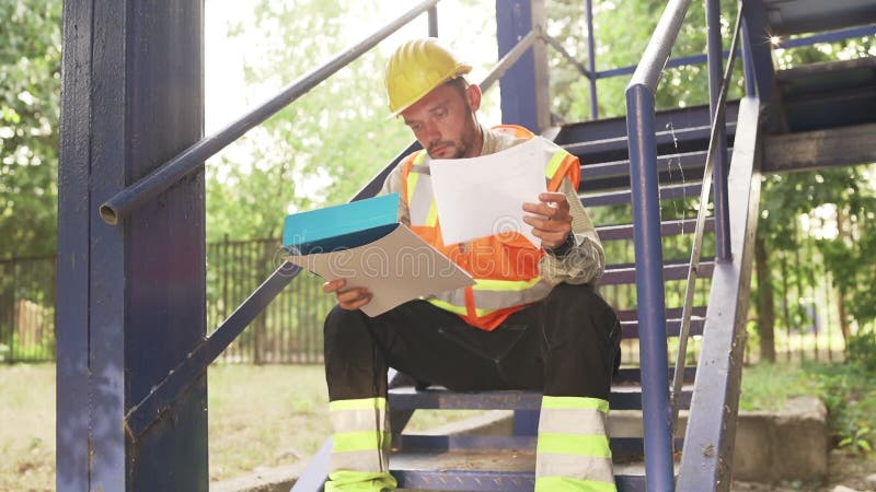 Architect Sitting on Stairs Looking Blueprint, Analyzing Building ...