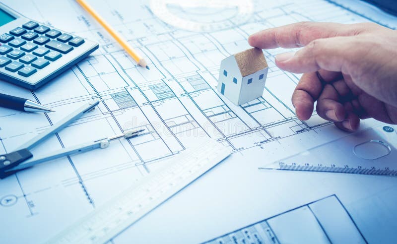 Architect with Small House Model on Hand and Plan Design.Concepts of ...
