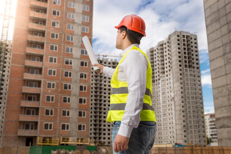 Male Architect Standing on Building Site and Pointing on Buildings ...