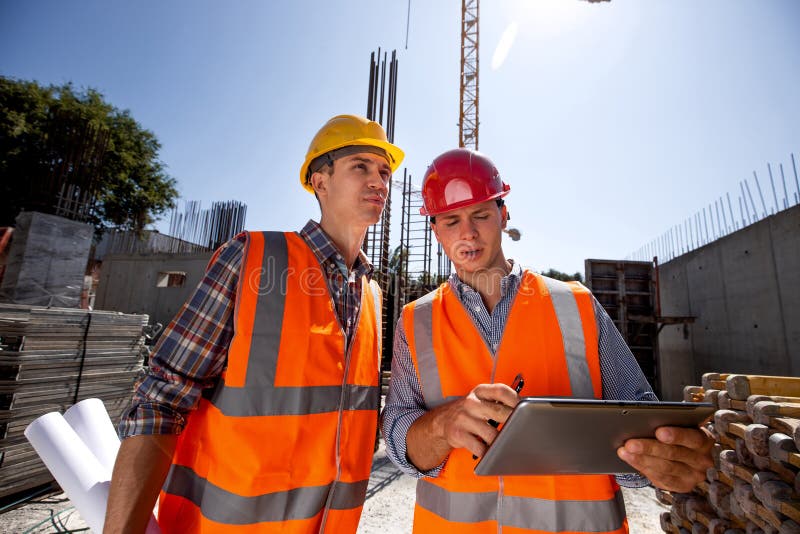 Architect and Structural Engineer Dressed in Orange Work Vests and ...