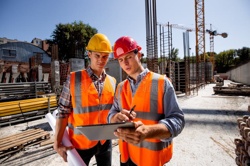 Architect and Structural Engineer Dressed in Orange Work Vests and ...