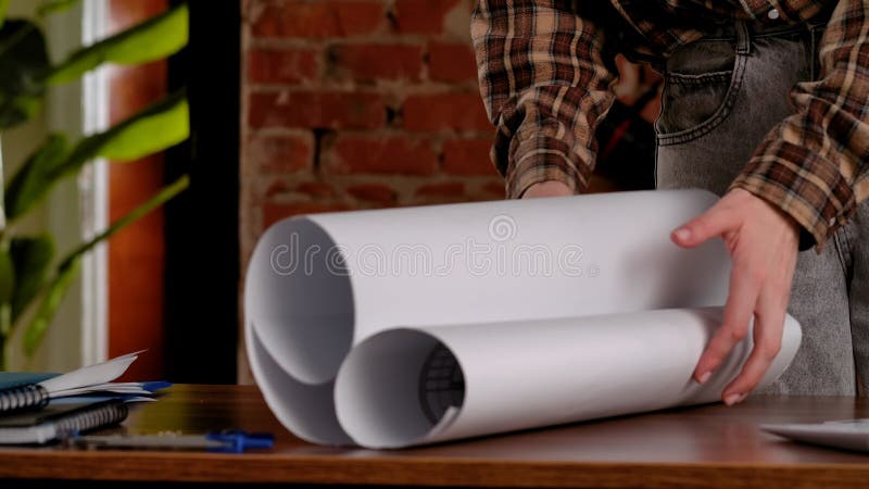 The Architect Takes Rolls of Building Plans and Interior Designs Out of ...