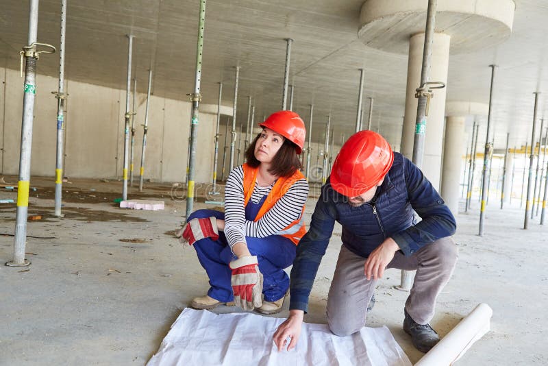 Architect Team with Floor Plan during Construction Planning Stock Photo ...