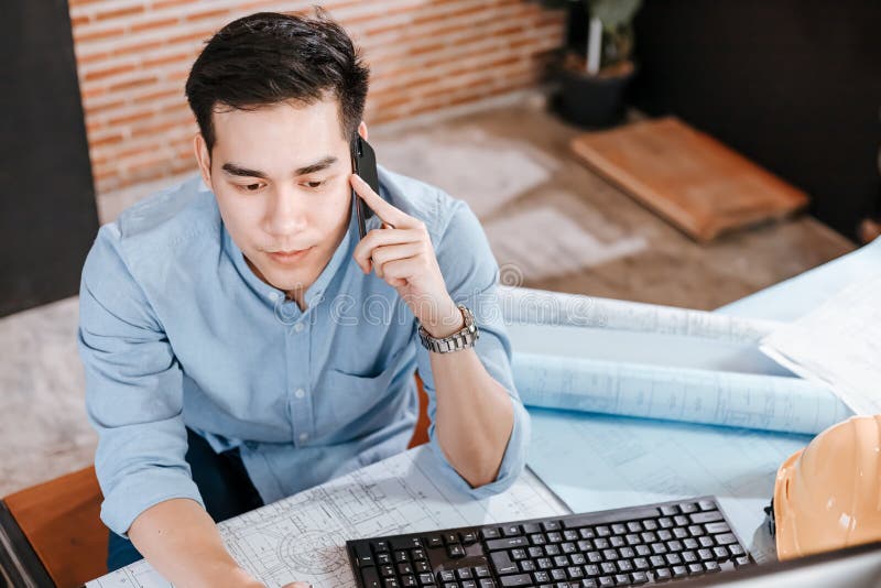 Architect Use Mobile Phone Call with Enginner and Reading a Building ...