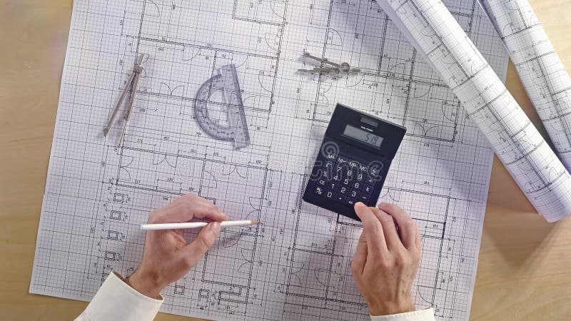 Architect Using Calculator on Architectural Blueprint House Building ...