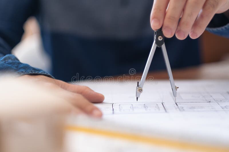 An Architect Using Compass To Draw and Measure Shop Drawing Stock Image ...