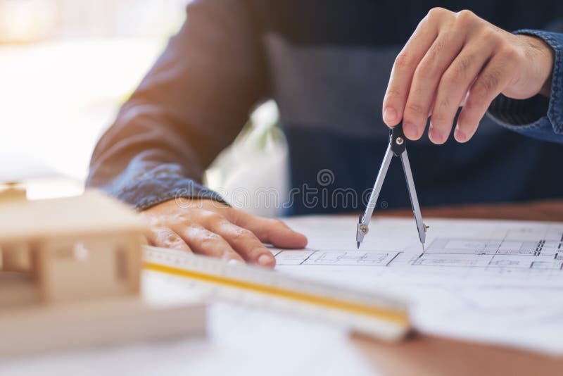 An Architect Using Compass To Draw and Measure Shop Drawing Stock Photo ...