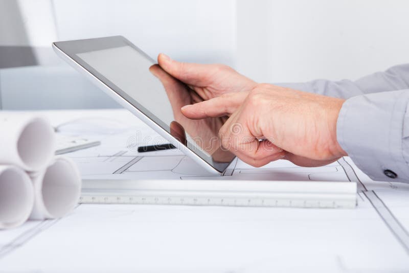 Architect Using Digital Tablet on Blueprint in Office Stock Photo ...