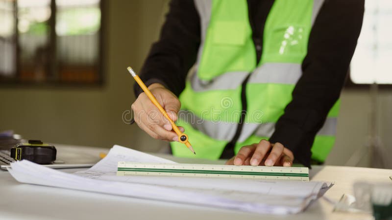 An Architect is Using a Ruler To Draw Precise Measurements for a ...