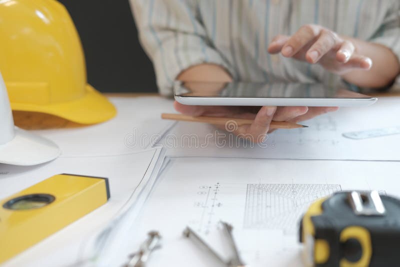 Architect Using Tablet. Engineer Working on House Blueprint of R Stock ...