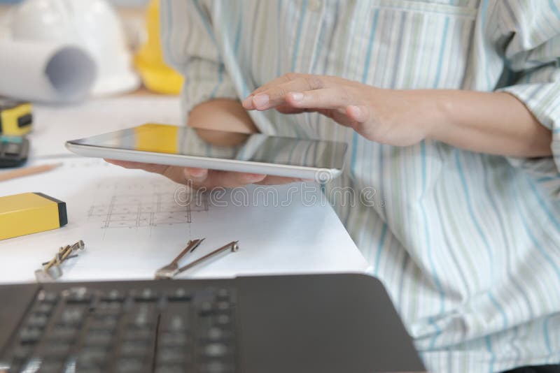 Architect Using Tablet. Engineer Working on House Blueprint of R Stock ...