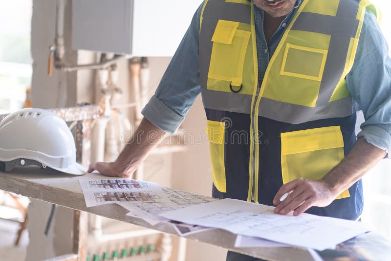 Architect in Vest Checking Project Papers and Documents Stands in Room ...