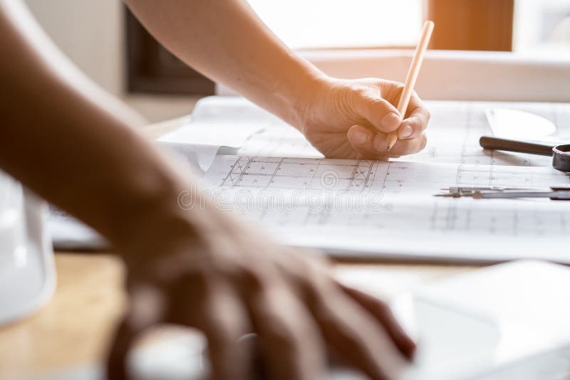 Close Up Hand of Architect Writing on the Blueprints in the Office ...