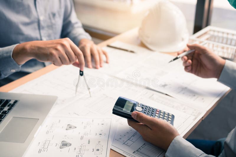 Architect Working on Blueprint in Workplace with Partnership and ...