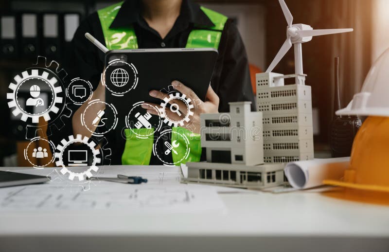 Architect Working with Blueprints for Sketching a Construction Project, Green Energy and Solar ...