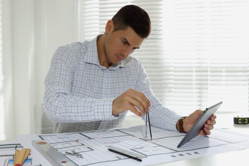 Architect Working with Construction Drawings in Office Stock Image ...