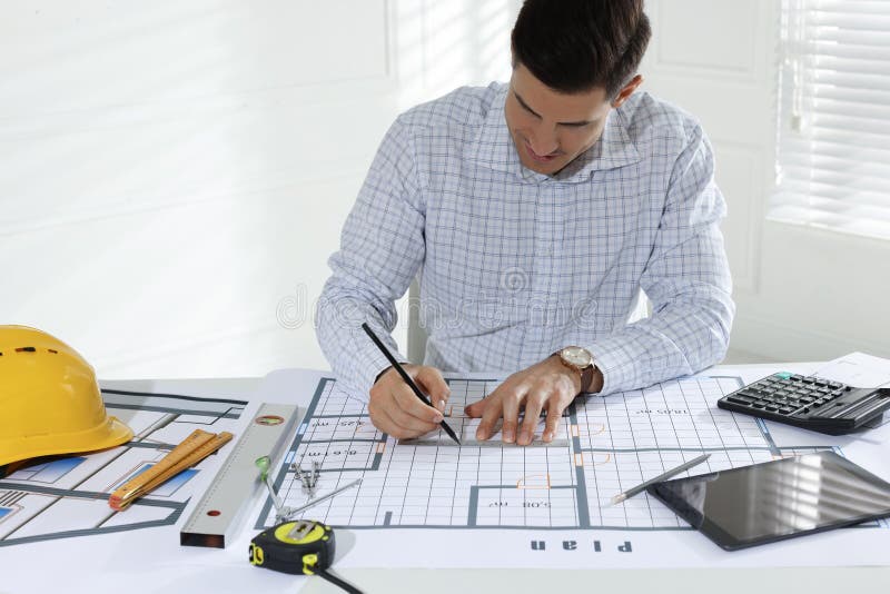 Architect Working with Construction Drawings in Office Stock Photo ...