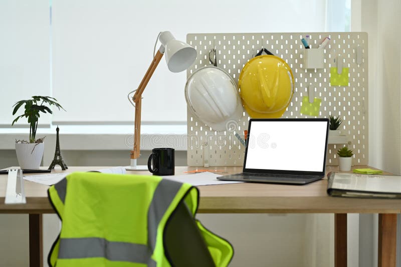 Architect Working Desk with Laptop Computer, Hardhat, Reflective Jacket ...