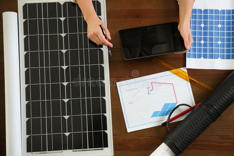 Architect Working on House Project with Solar Panels at Wooden Table ...