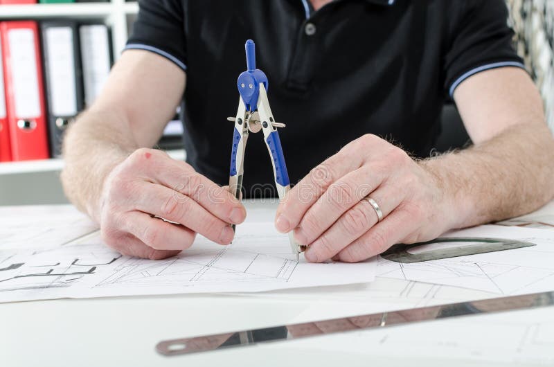 Architect working on plans stock image. Image of home - 54522287