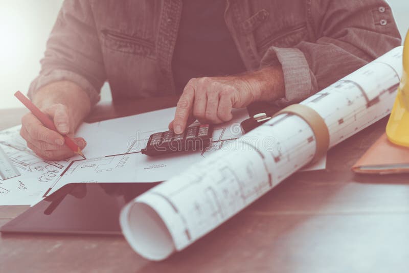 Architect working on plans stock photo. Image of house - 102423880