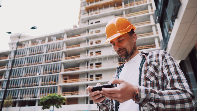 Architect Working with Smartphone on Construction Site. Engineer Check ...