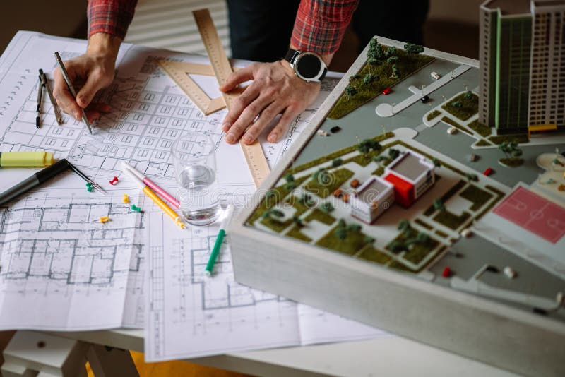 Architects Creating New Project with the Use of Small Model of High ...