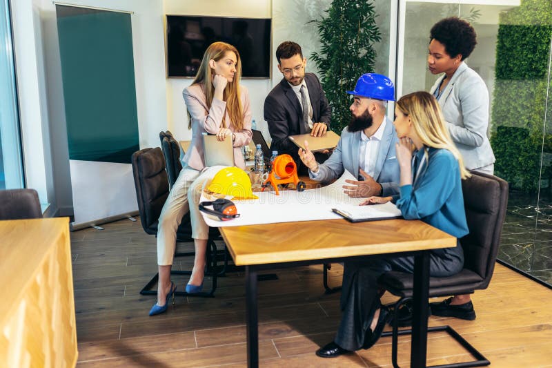 Architects, Designers and Engineers Working on Project Together in a ...