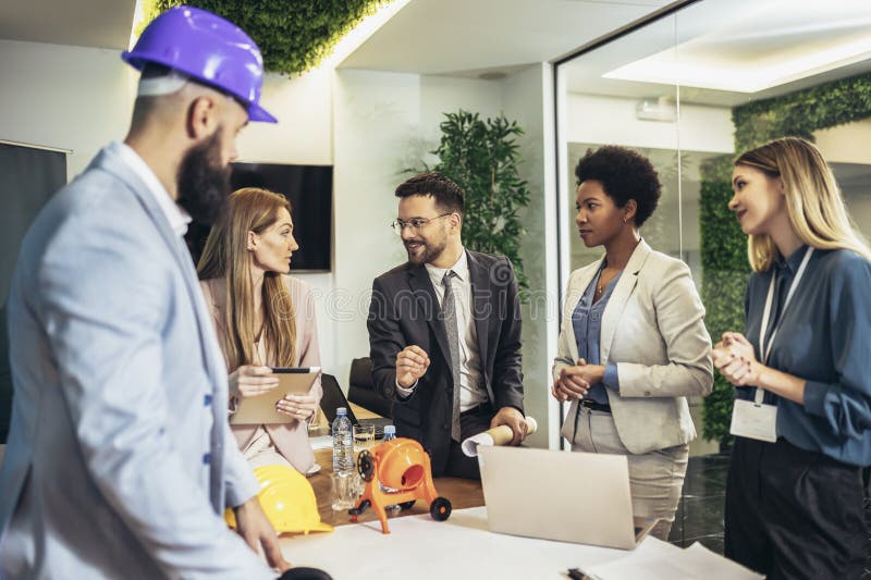 Architects, Designers and Engineers Working on Project Together in a ...