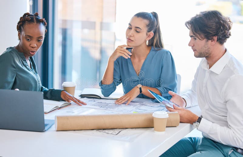 Architects, Designers and Engineers Working Together As a Team on Construction Plans and ...