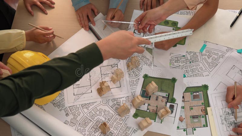 Architects Discuss about House Construction Design with Blueprint ...