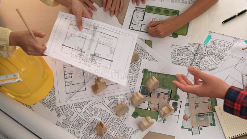 Architects Discuss about House Construction Design with Blueprint ...