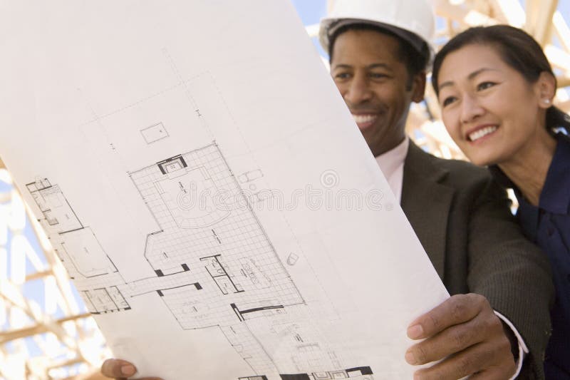 Architects in Discussion Over Blueprint Stock Image - Image of ...