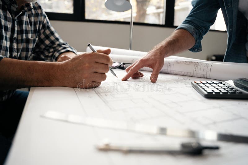 Architects Engineer Discussing at the Table with Blueprint - Closeup on ...