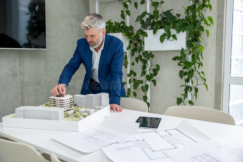 Architects or Engineer Working with Blueprint and House Model in the ...