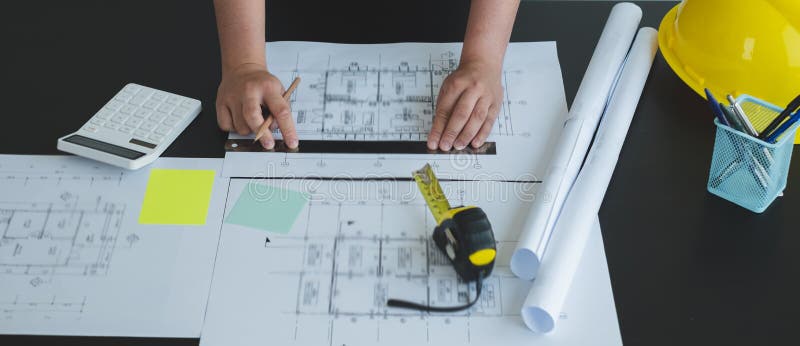 Architects or Engineers Working Construction and Drawing Construction Plans, Printing, Writing ...