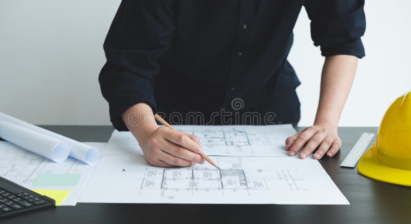Architects or Engineers Working Construction and Drawing Construction Plans, Printing, Writing ...