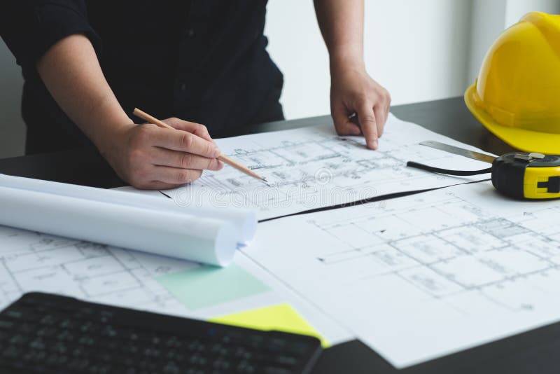 Architects or Engineers Working Construction and Drawing Construction ...
