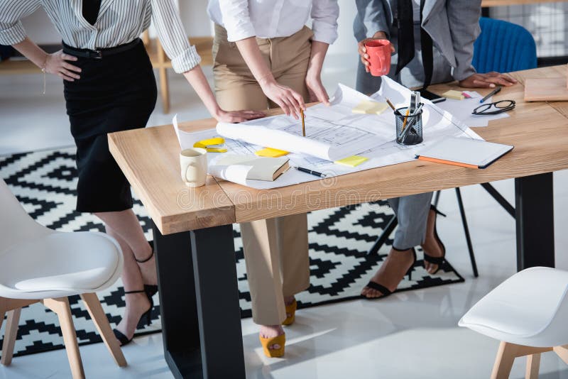 Architects in Formal Wear Working with Blueprints at Table Stock Photo ...